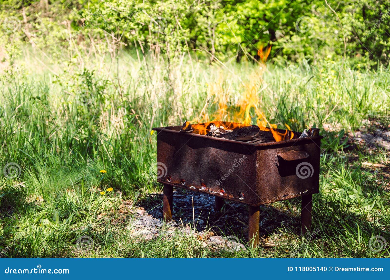 The Fire in the Time-worn Brazier on Green Plants Backgroun. Close-up ...