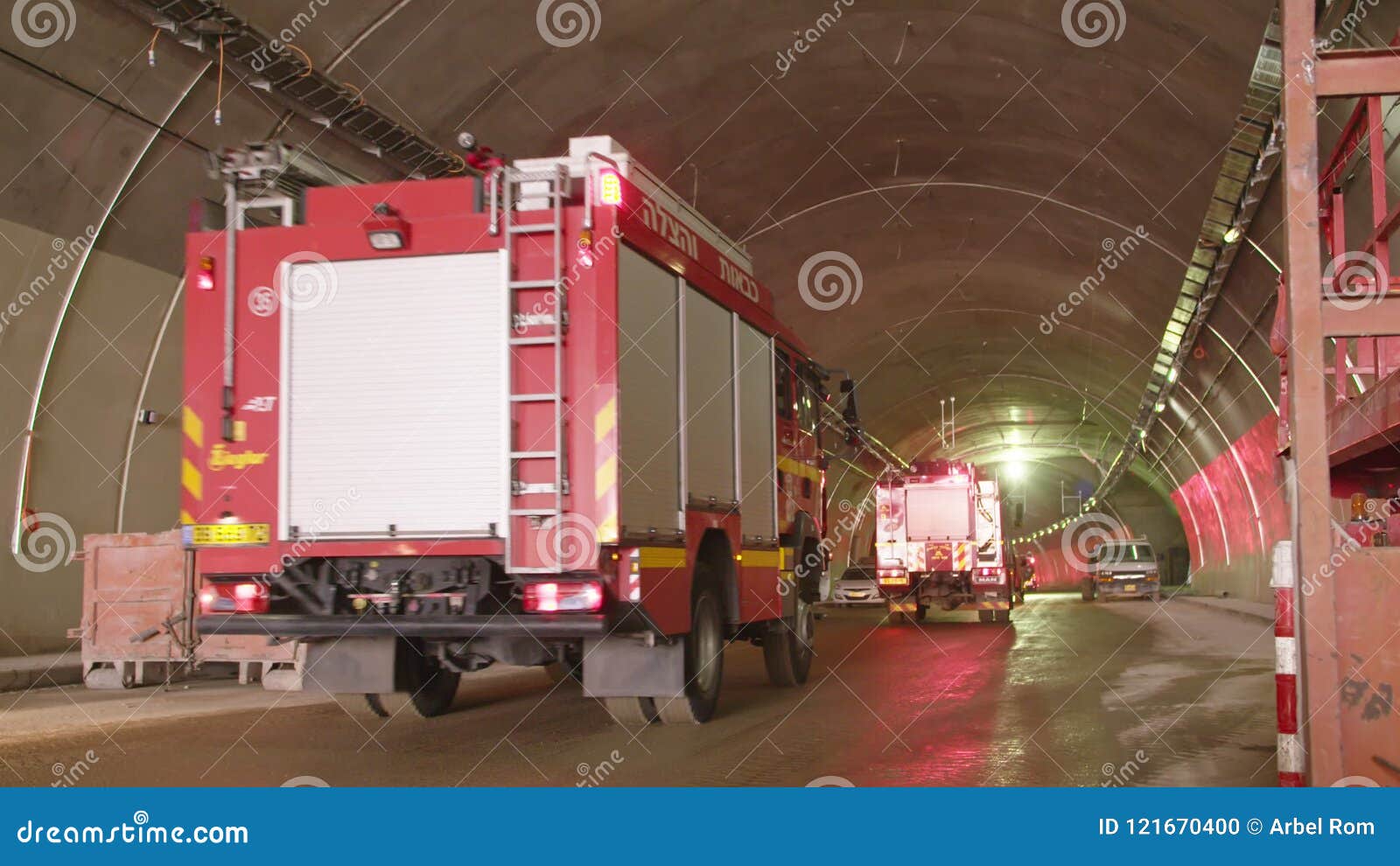Fire Trucks Entering a Large Tunnel with Red Lights for Rescue Stock ...