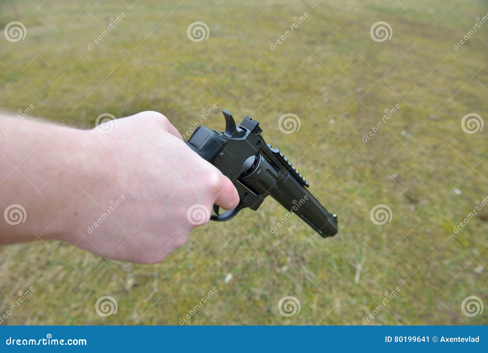 Firearms and Security Topic: Hand Man with a Gun Ready To Shoot Stock ...