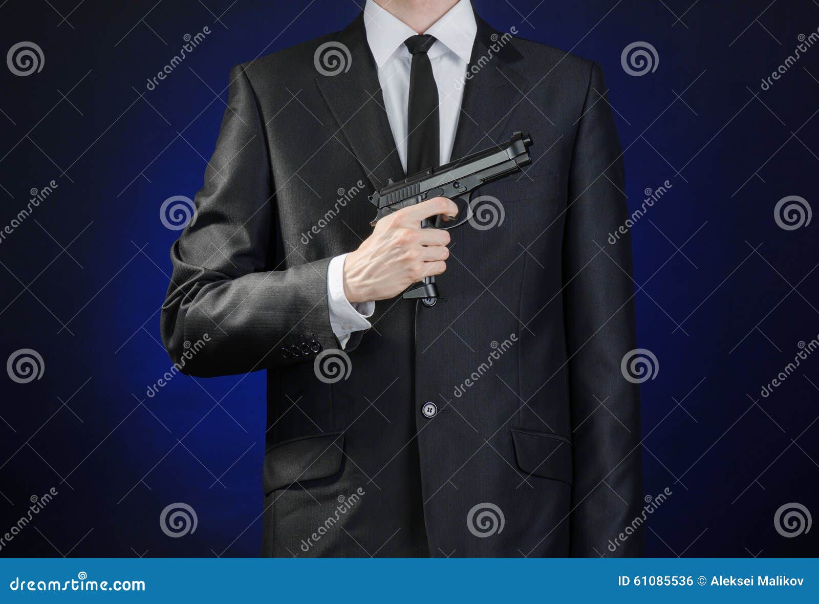 Firearms and Security Topic: a Man in a Black Suit Holding a Gun on a ...