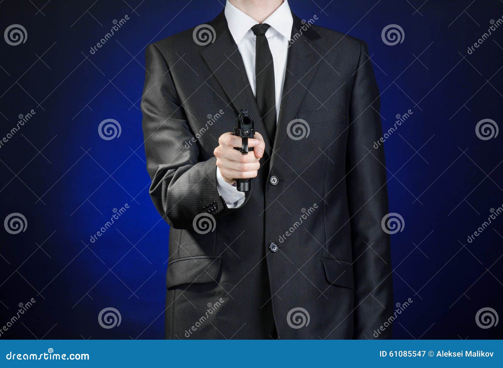 Firearms and Security Topic: a Man in a Black Suit Holding a Gun on a ...
