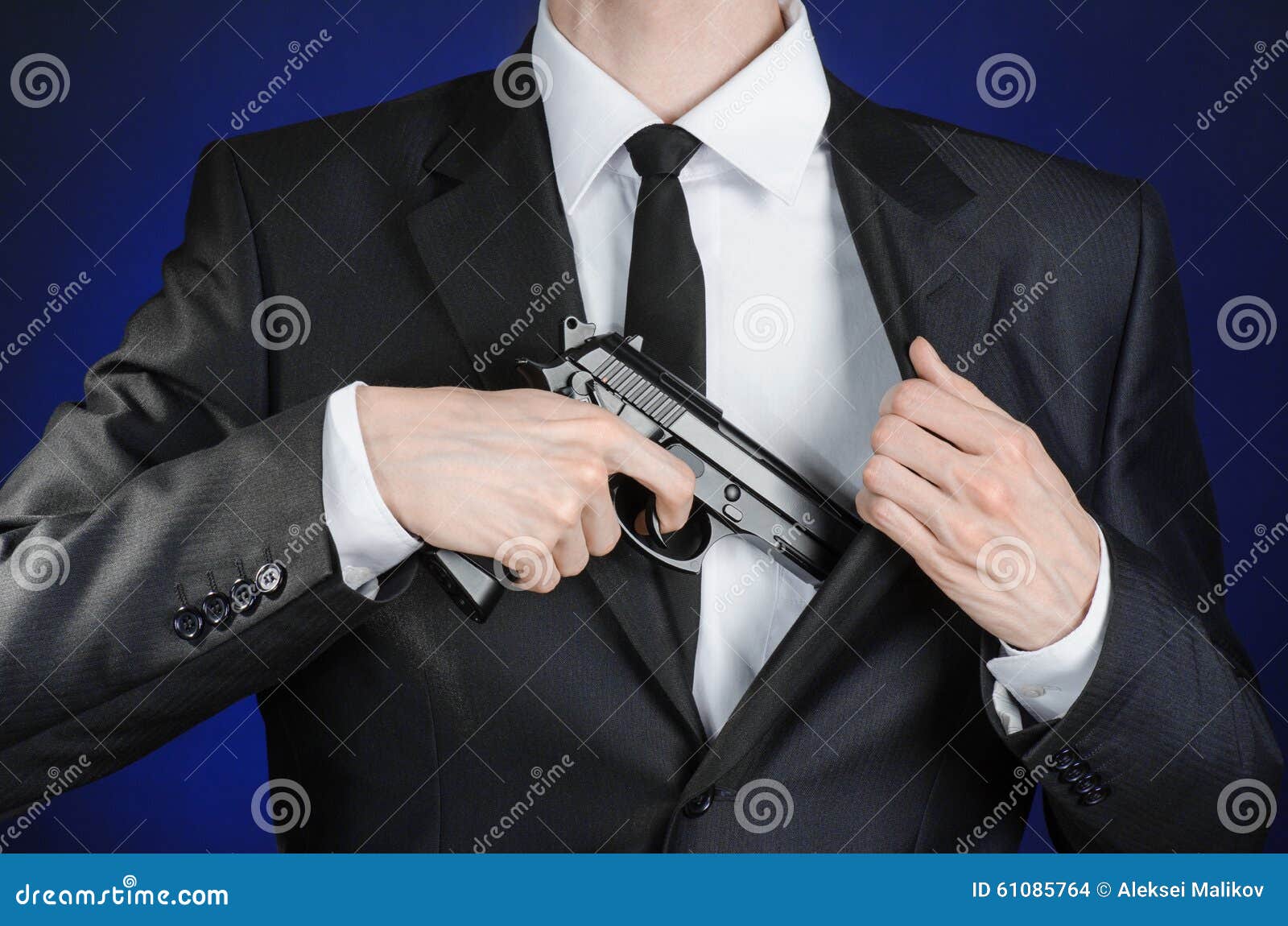 Firearms and Security Topic: a Man in a Black Suit Holding a Gun on a ...