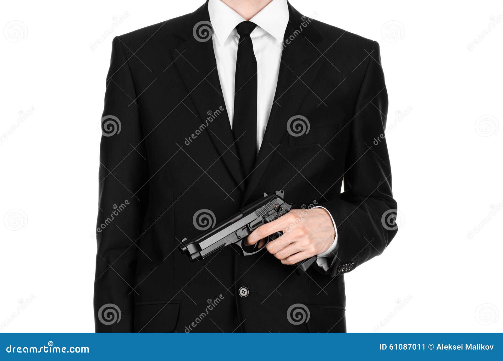 Firearms And Security Topic: A Man In A Black Suit Holding A Gun On An ...