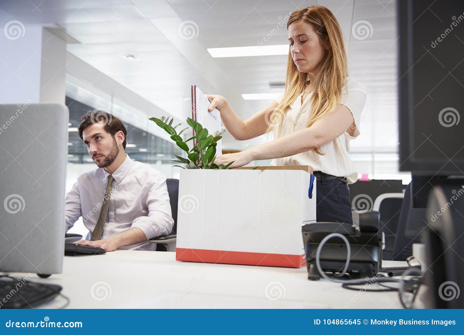 Fired Female Employee Packing Box of Belongings in an Office Stock ...