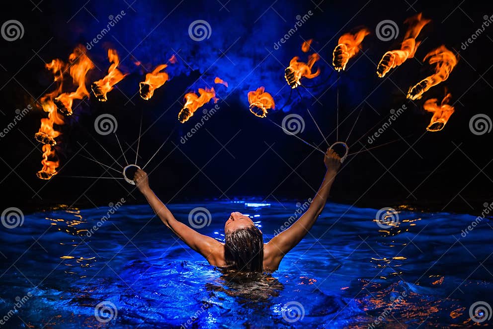 Firedancer woman in water stock image. Image of dancing - 51567411