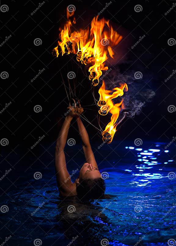 Firedancer woman in water stock photo. Image of hair - 53594824