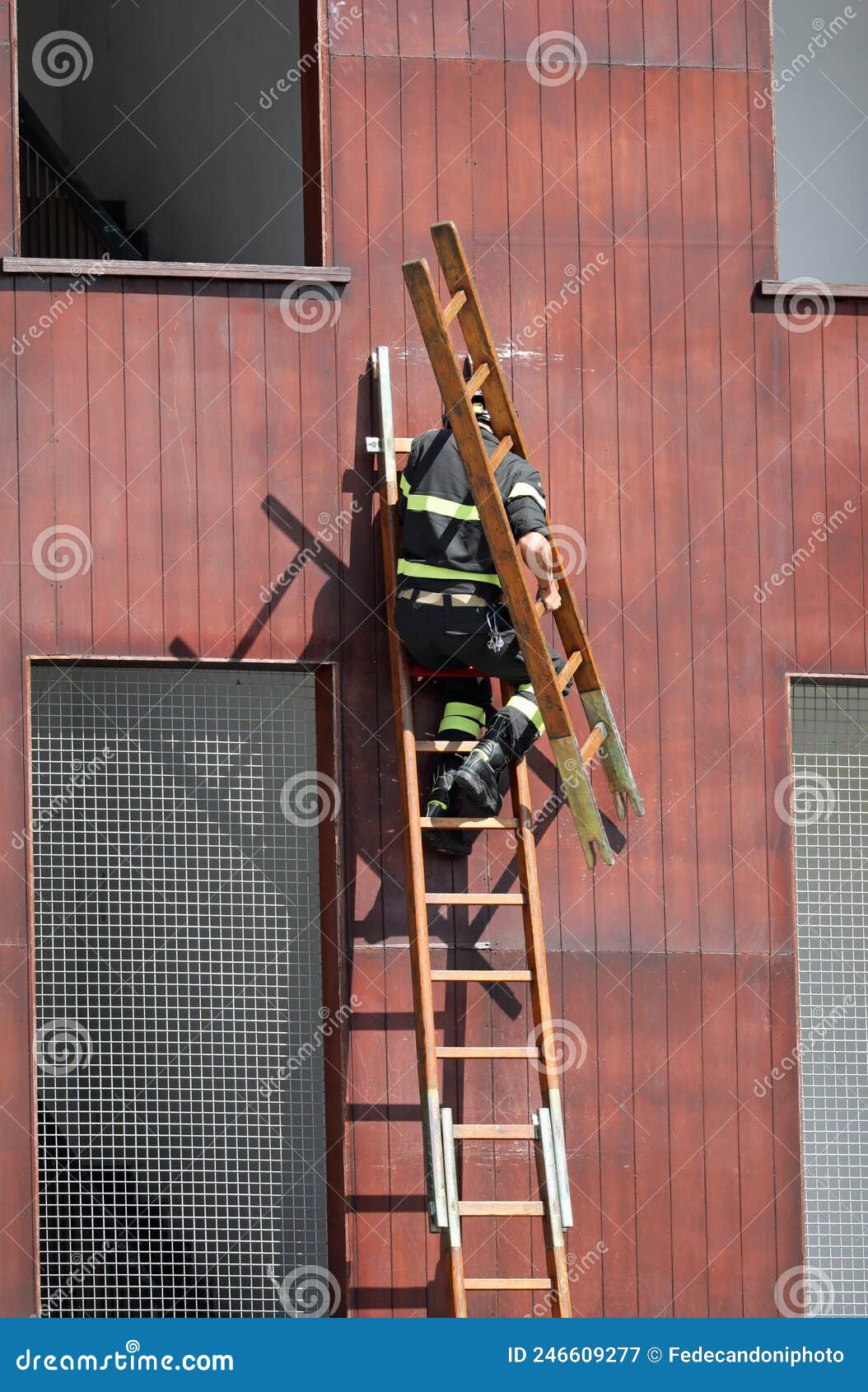 Firefighter in Action in the Fire Station with the Long Ladder Stock ...