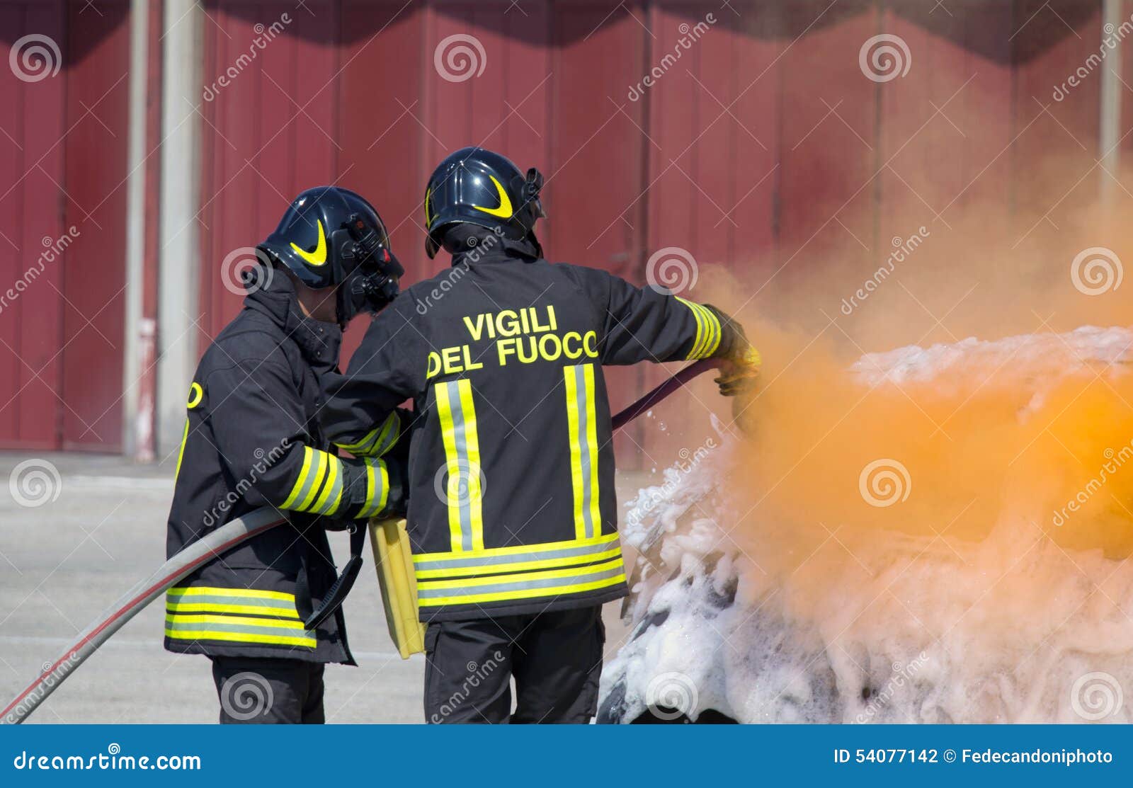 Firefighter in Action with Foam To Put Out the Fire Stock Photo - Image ...