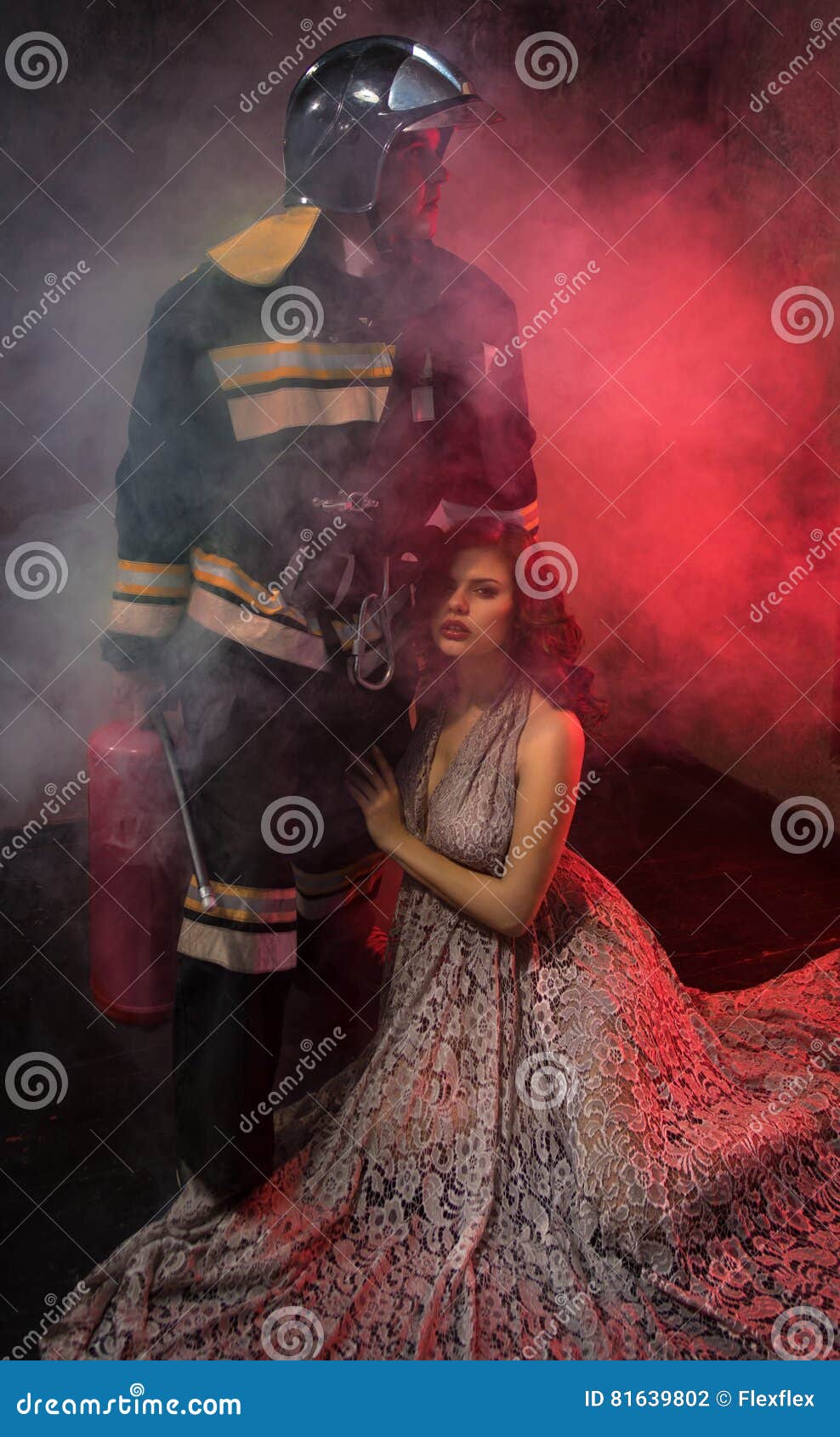 A Firefighter with Beautiful Women in Long Dress Stock Photo - Image of ...