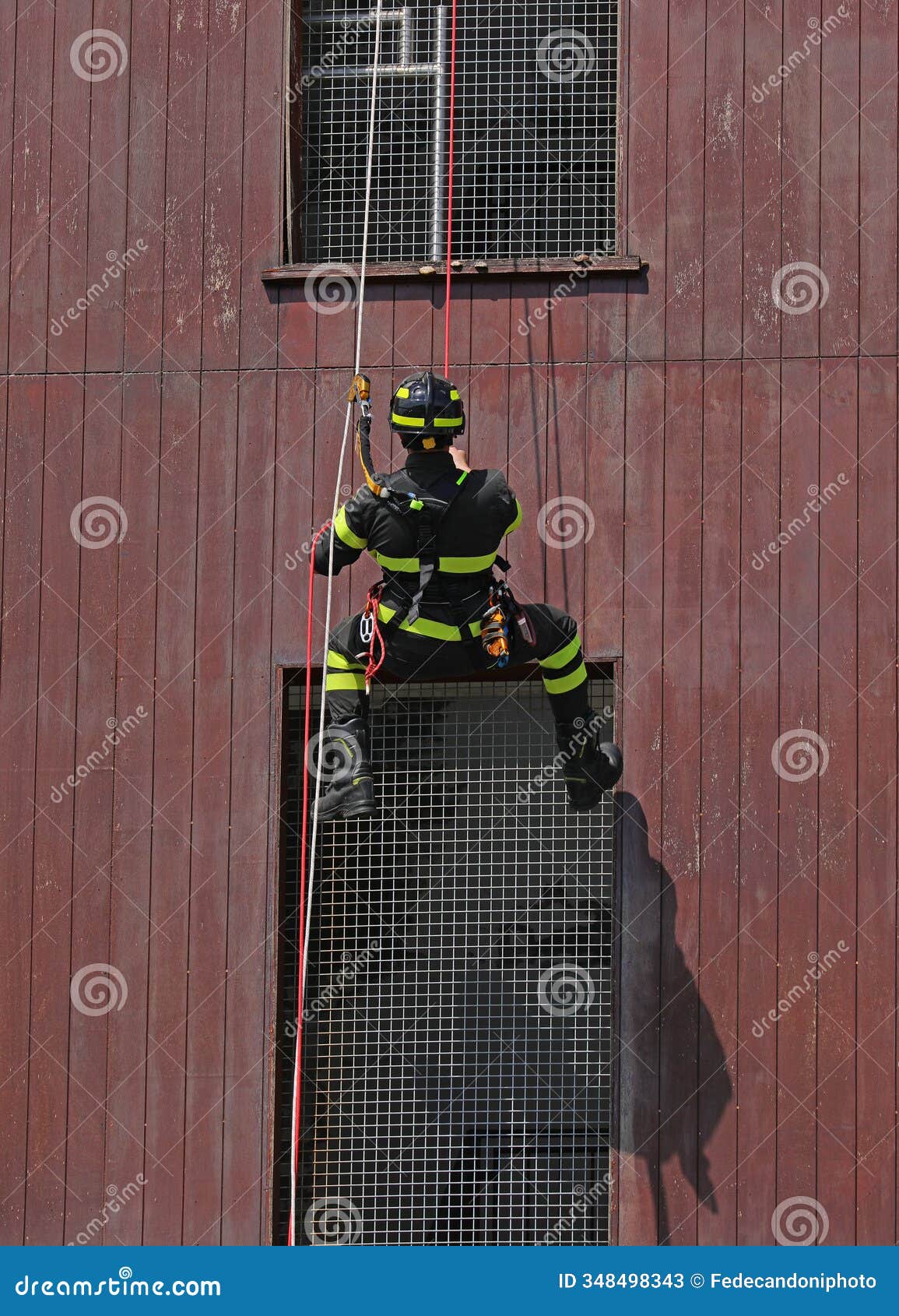 Firefighter Climbing a Building with a Safety Harness, Ropes Stock ...