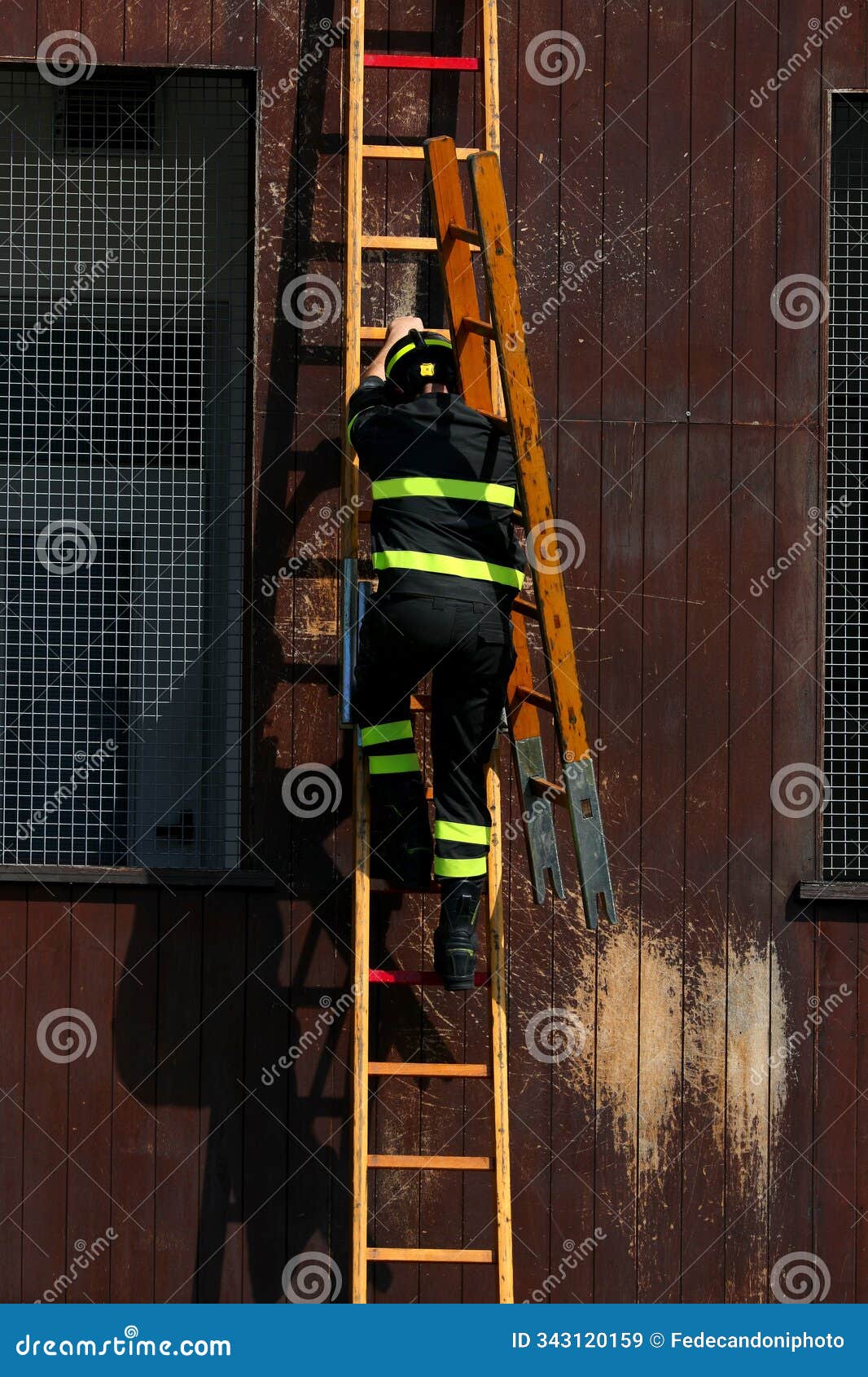 Firefighter is Climbing a Wooden Ladder during a Training Exercise ...