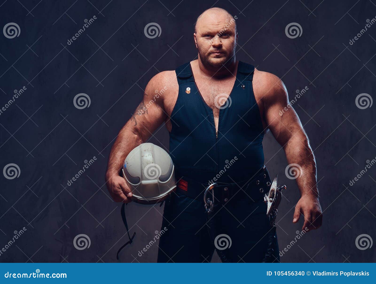 Firefighter Dressed in a Uniform Holds White Fire Helmet. Stock Photo ...
