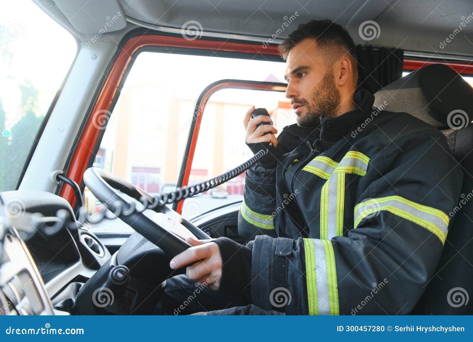 Firefighter Drives a Emergency Vehicle with Communication Interior View ...