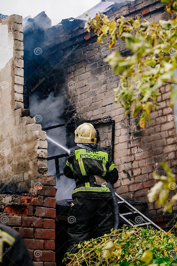 Firefighter Extinguish Fire in House Using Spraying Hose Stock Image ...
