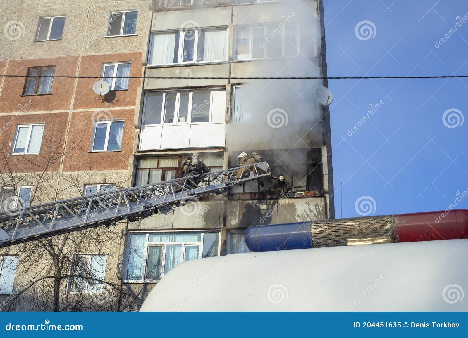 A Firefighter Extinguishes a Balcony, in a High-rise Building, from a ...