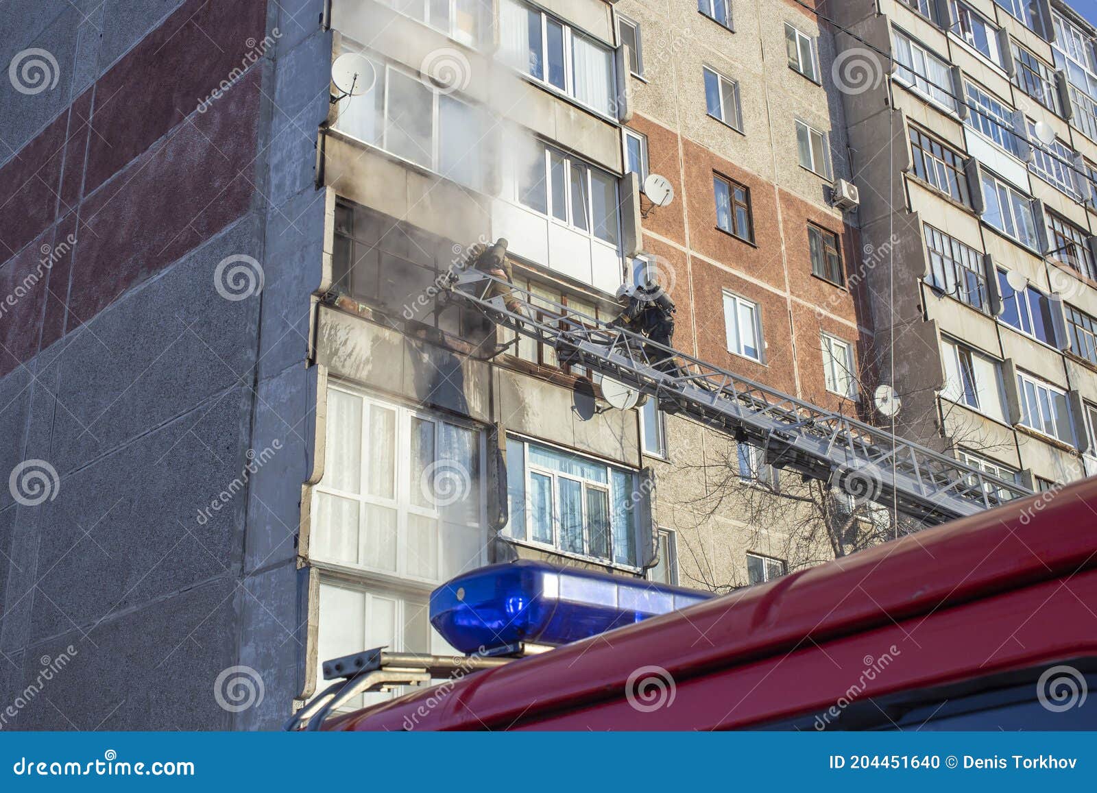 A Firefighter Extinguishes a Balcony, in a High-rise Building, from a ...
