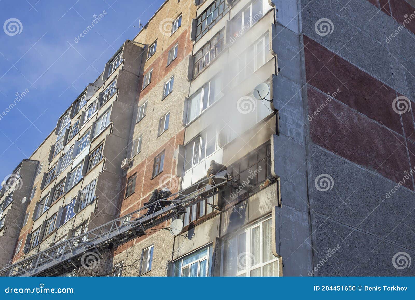 A Firefighter Extinguishes a Balcony, in a High-rise Building, from a ...