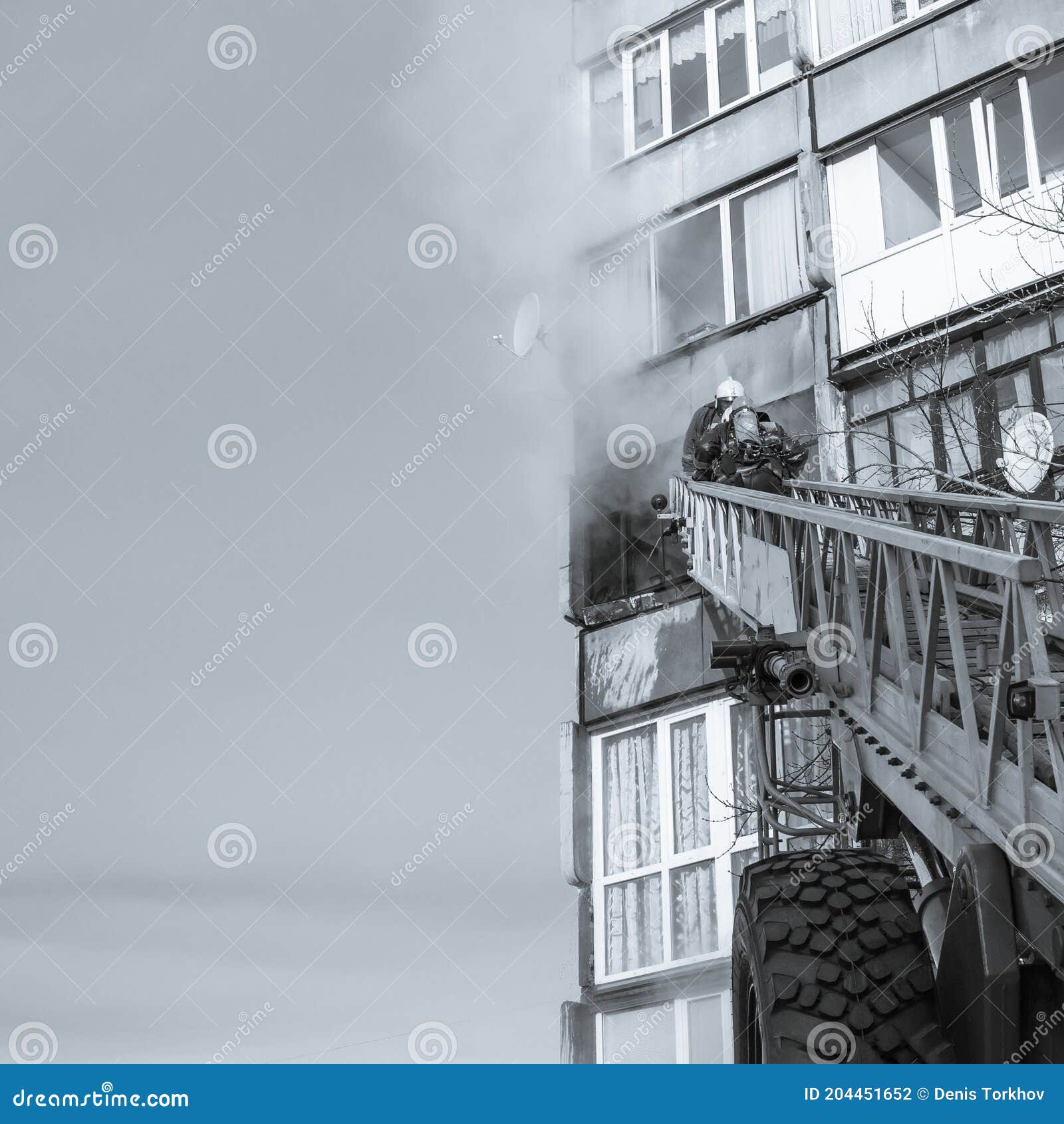 A Firefighter Extinguishes a Balcony, in a High-rise Building, from a ...