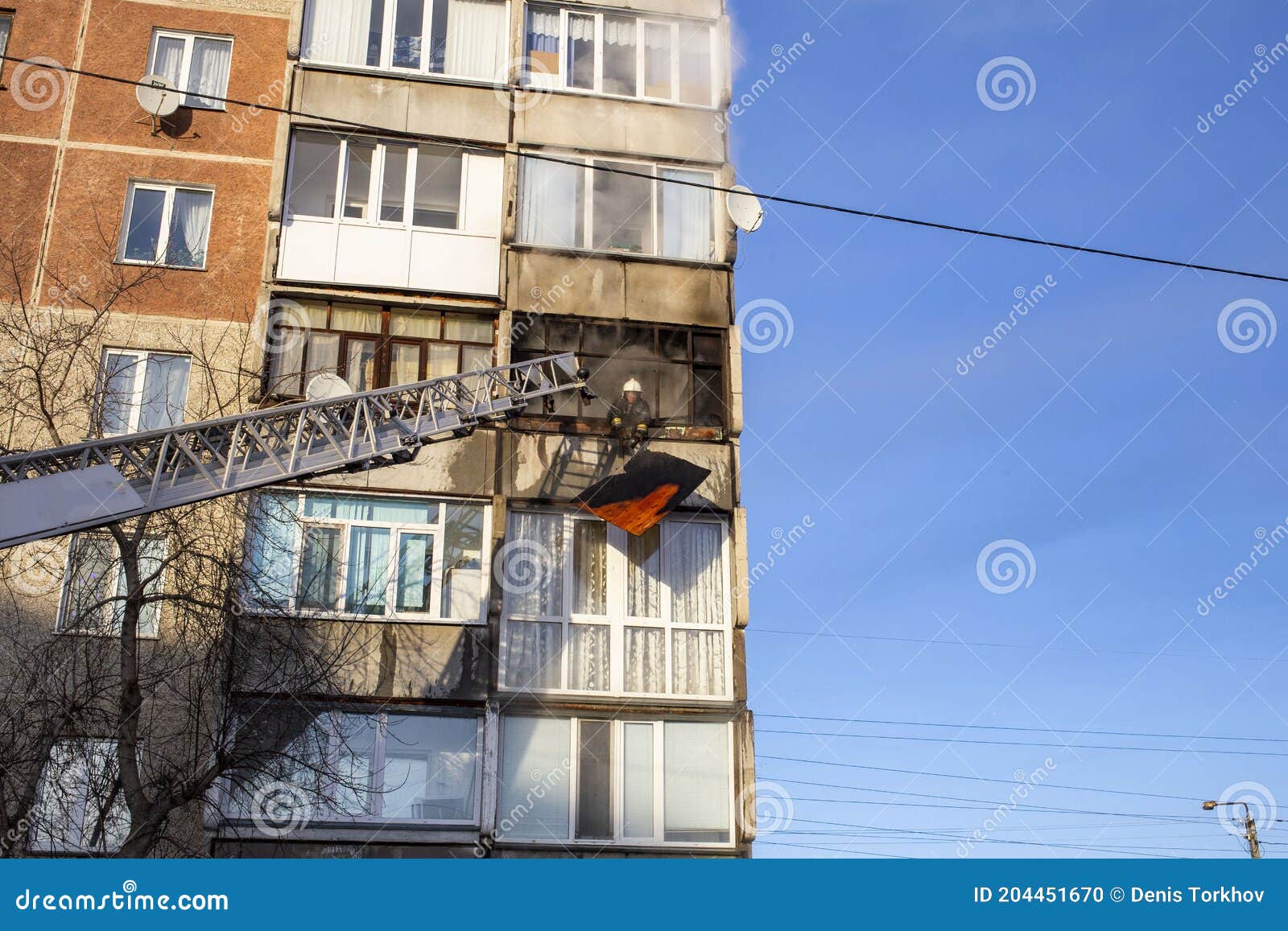 A Firefighter Extinguishes a Balcony, in a High-rise Building, from a ...