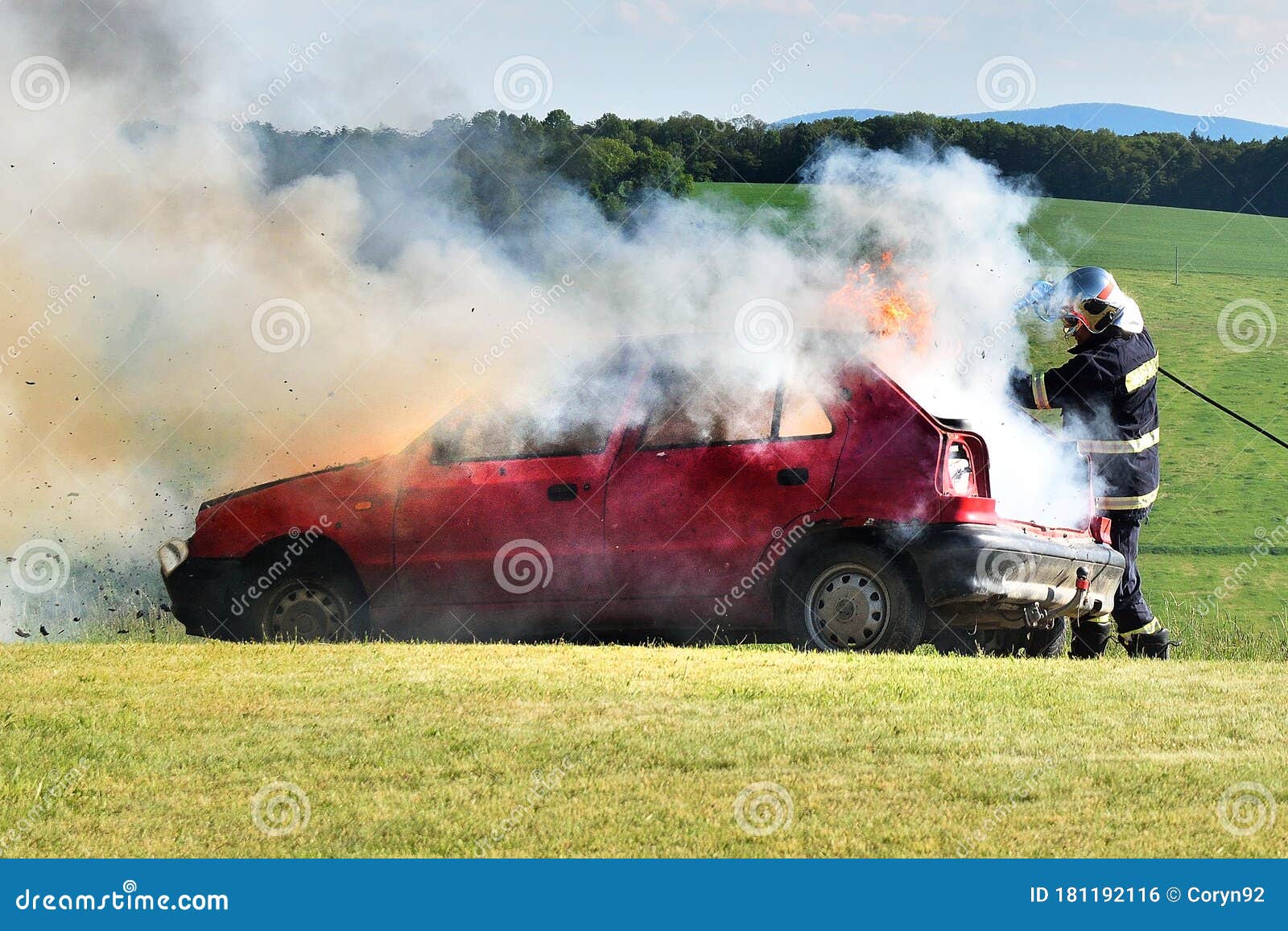 A Firefighter Extinguishes a Car Fire. Red Car on Fire, Smoke and ...