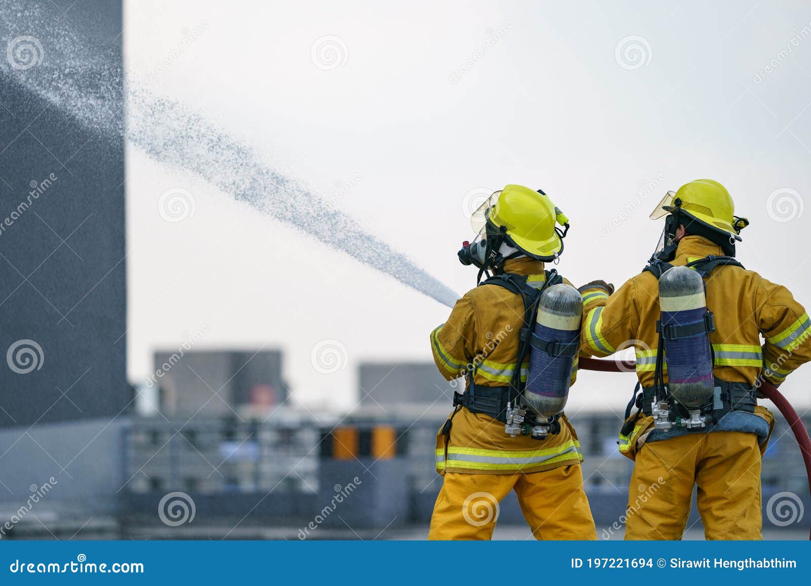 Firefighter or Fireman Team Work Water Spray by High Pressure Nozzle To ...