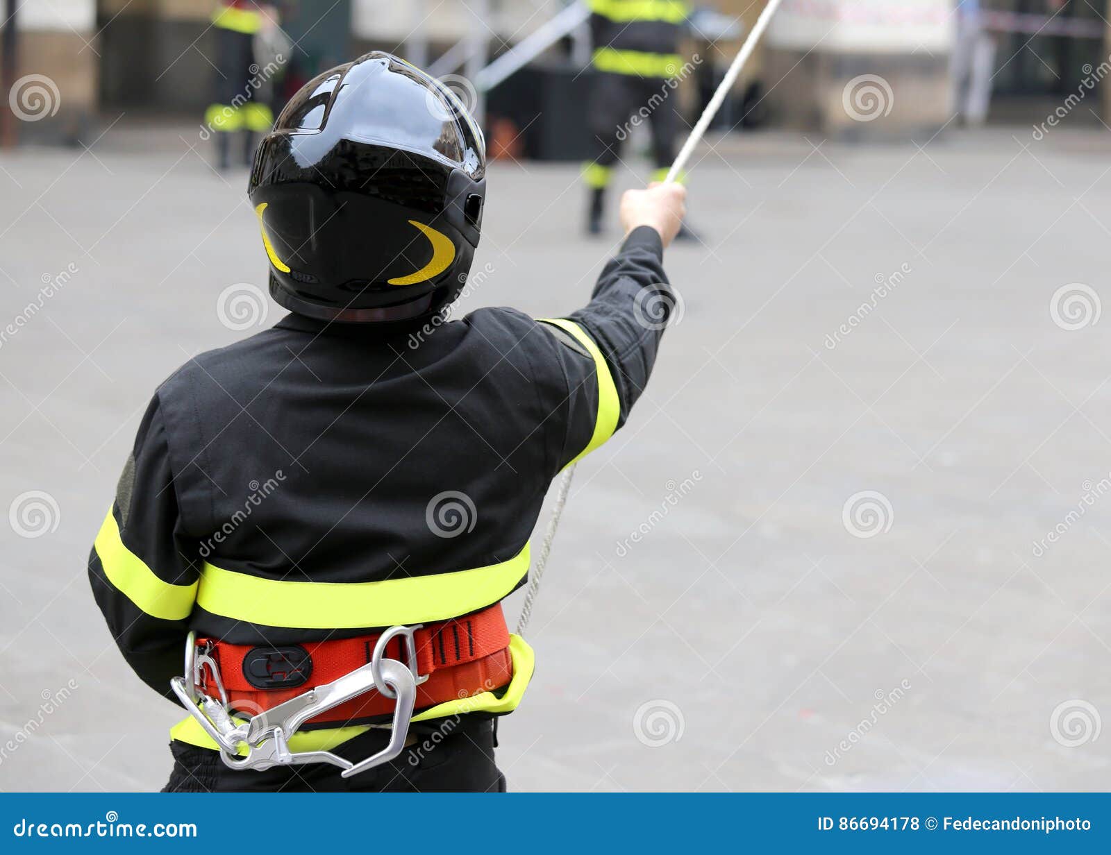 Firefighter with Hardhat during Rescue Operations with a Rope Stock ...