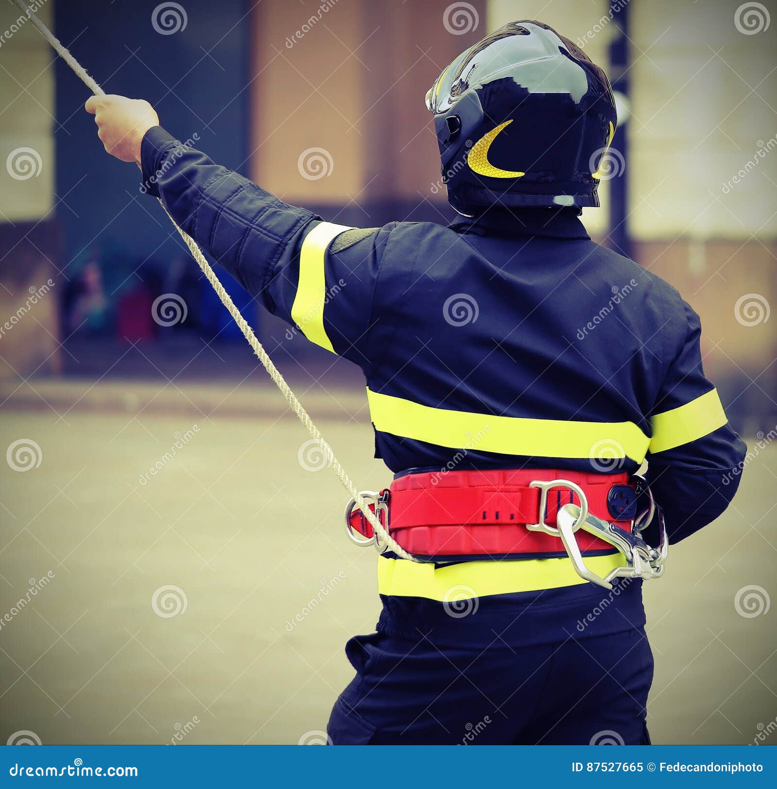 Firefighter with Hardhat during Rescue Operations with a Rope Stock ...