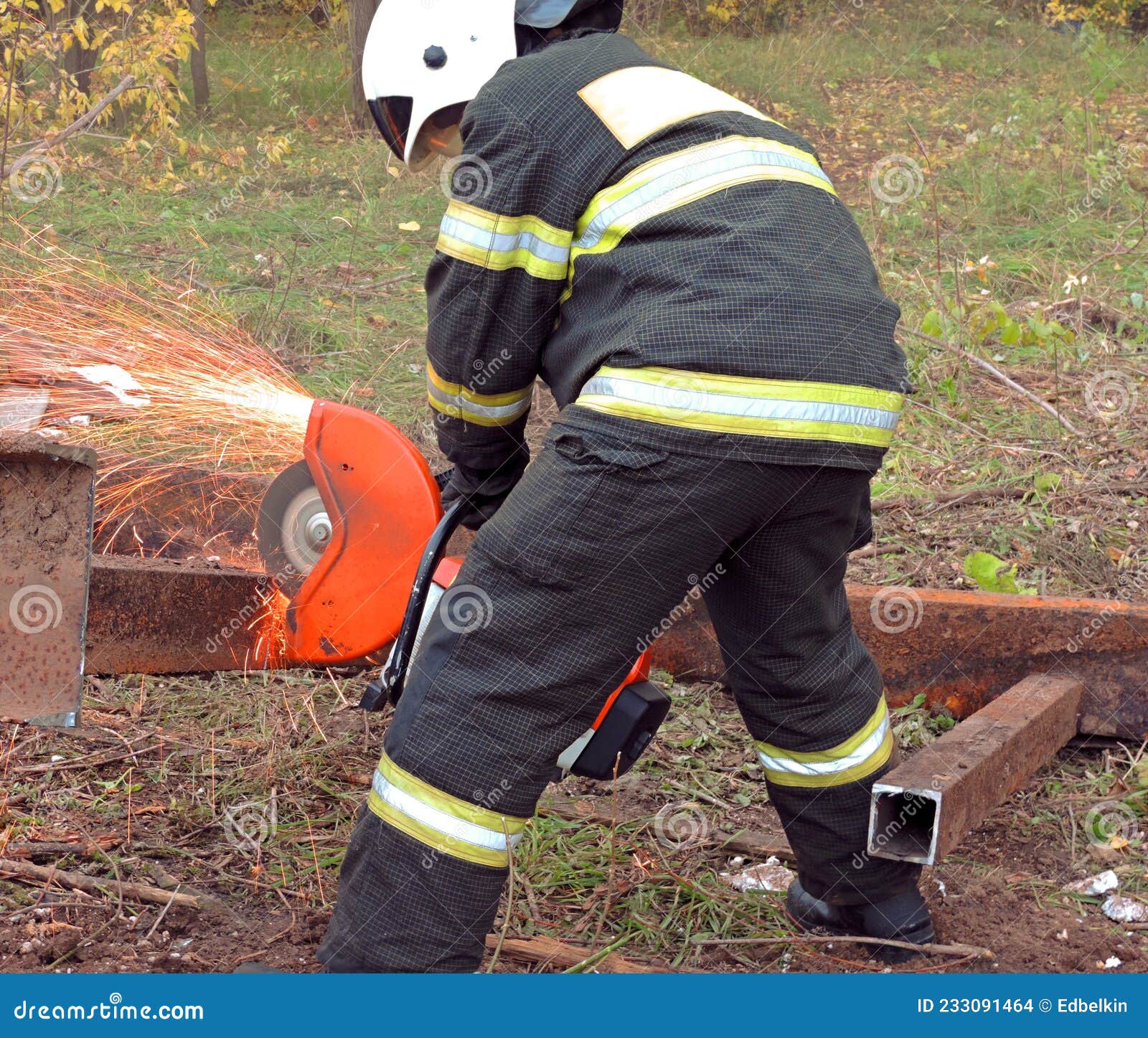 A Firefighter with the Help of an Emergency Rescue Tool Cuts a Metal ...
