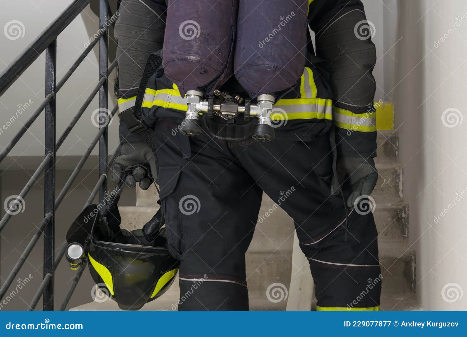 Firefighter Holding Helmet in Hands, Bottom Close-up View, Back View ...