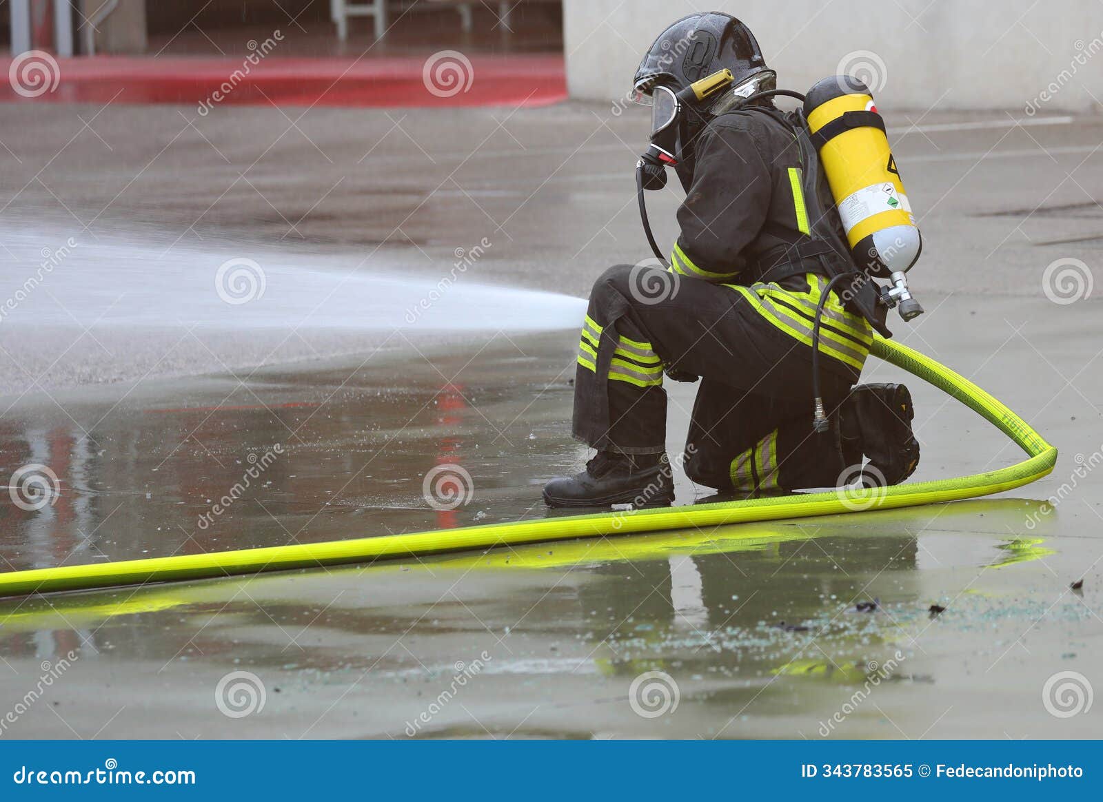 Firefighter with a Hose Spraying Foam Extinguishing Agent and an Oxygen ...