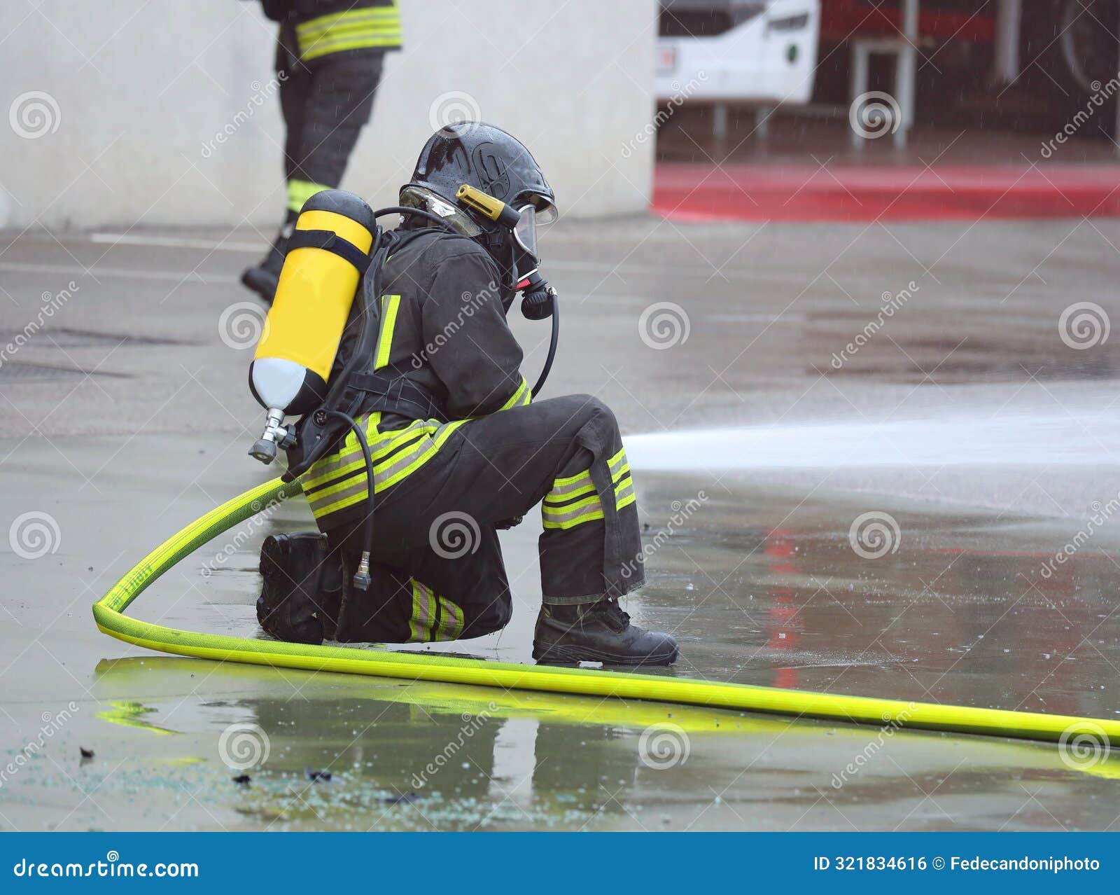 Firefighter Kneeling To Avoid Flames with Oxygen Tank during Fire ...