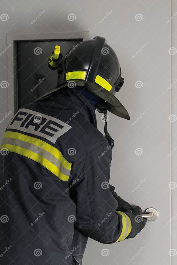 Firefighter Looking through a Closed Door Window Stock Photo - Image of ...