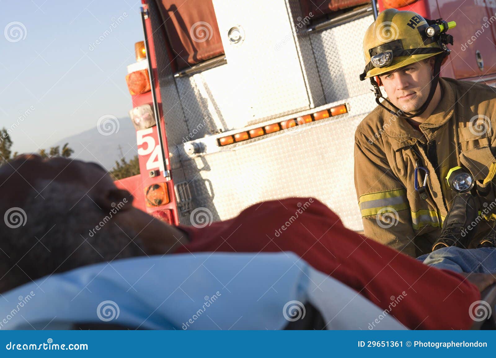 Firefighter Looking at Patient Stock Image - Image of people, adult ...