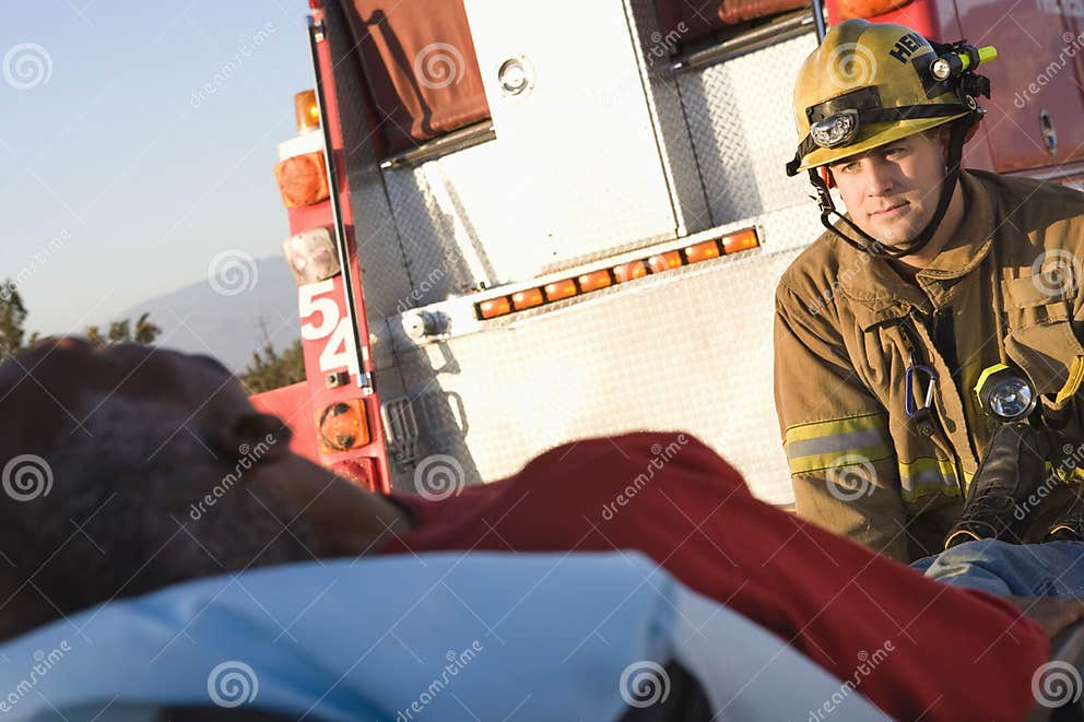 Firefighter Looking at Patient Stock Image - Image of people, adult ...