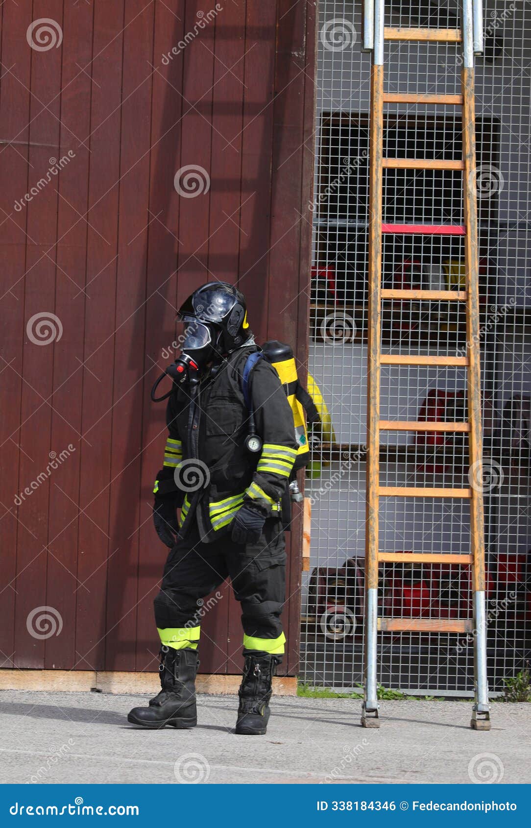 Firefighter With An Oxygen Tank In The Firehouse During A Training ...