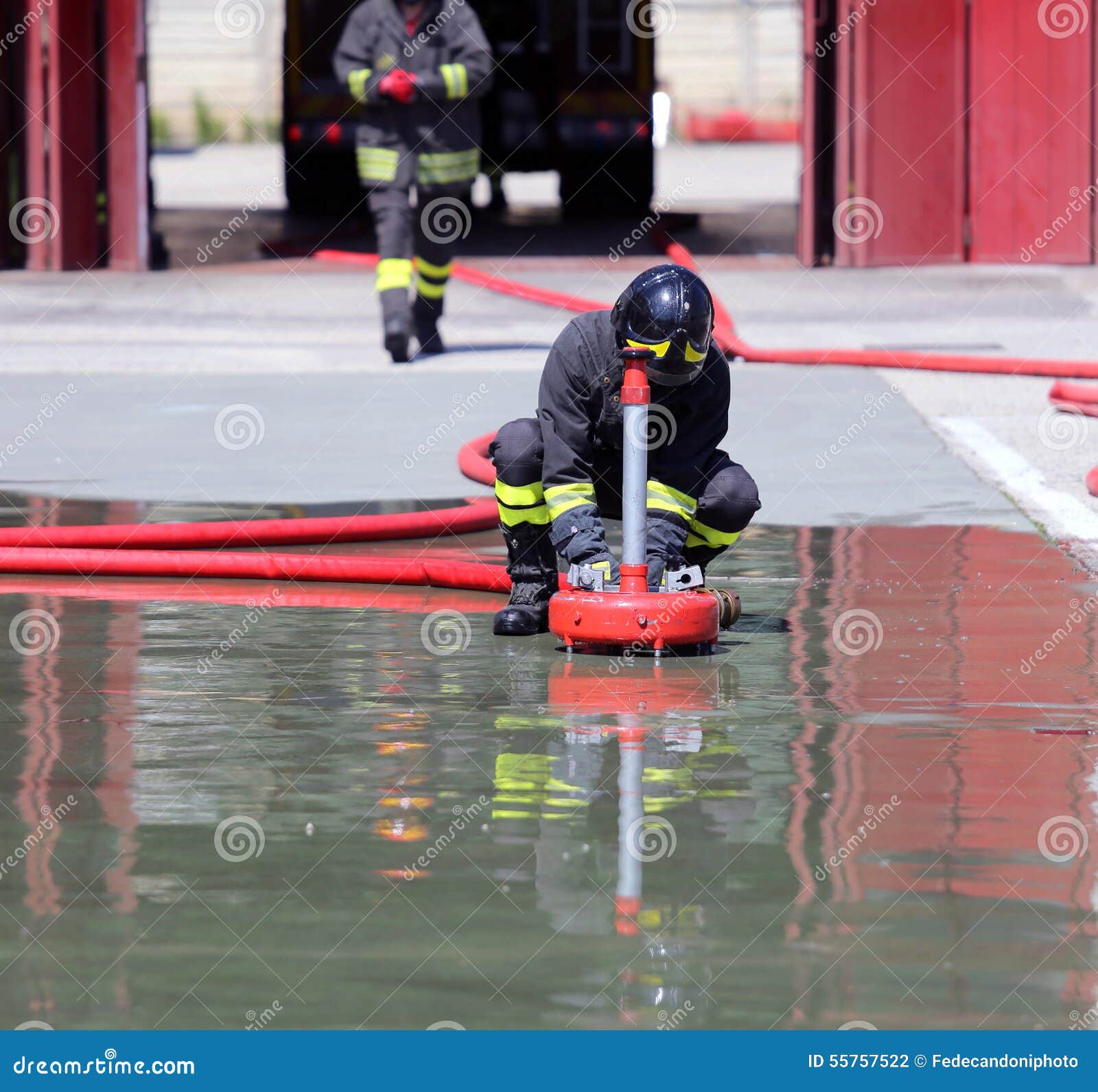 Firefighter Positions A Powerful Fire Hydrant During The Exercises In ...
