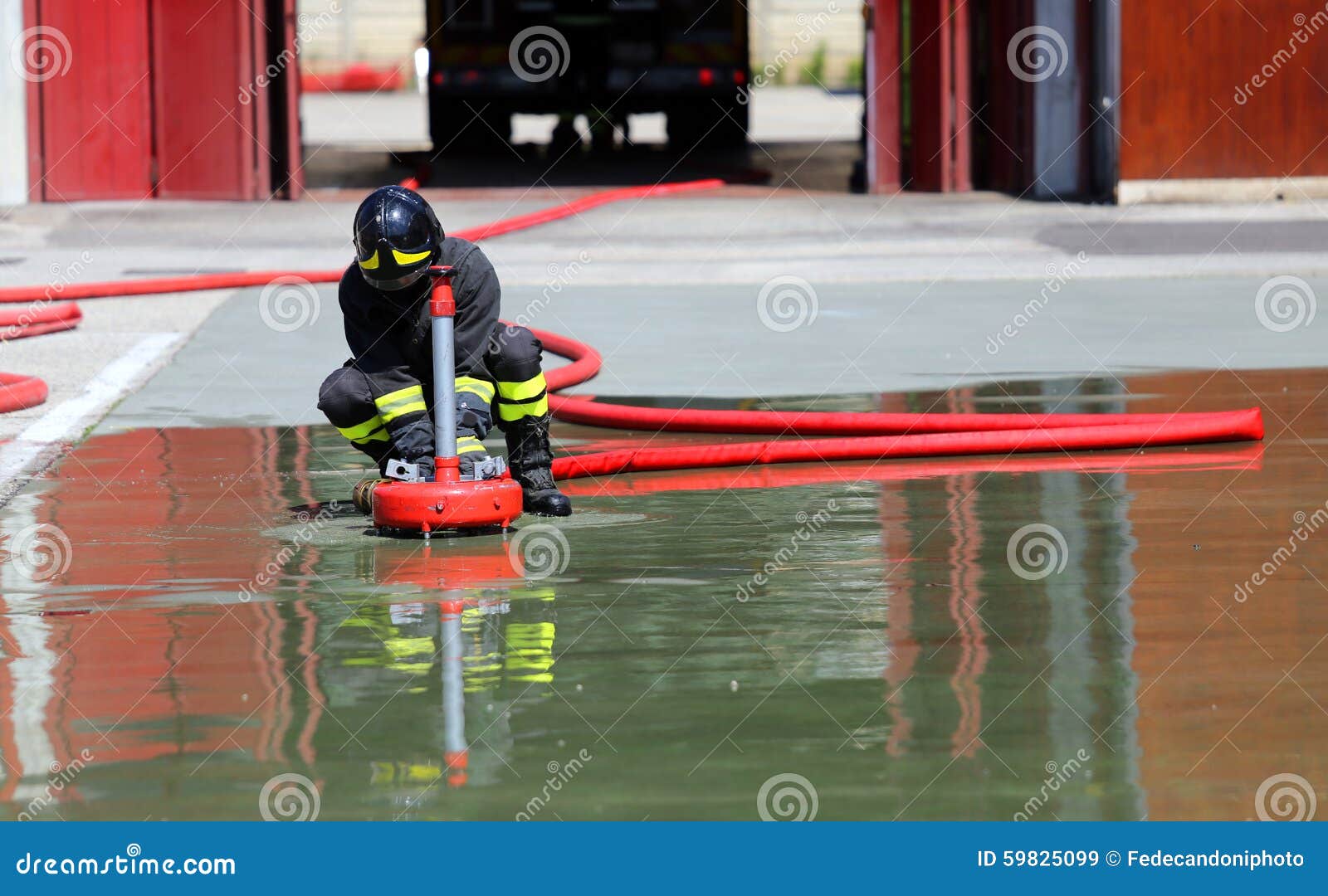 Firefighter Positions A Powerful Fire Hydrant During The Exercises In ...