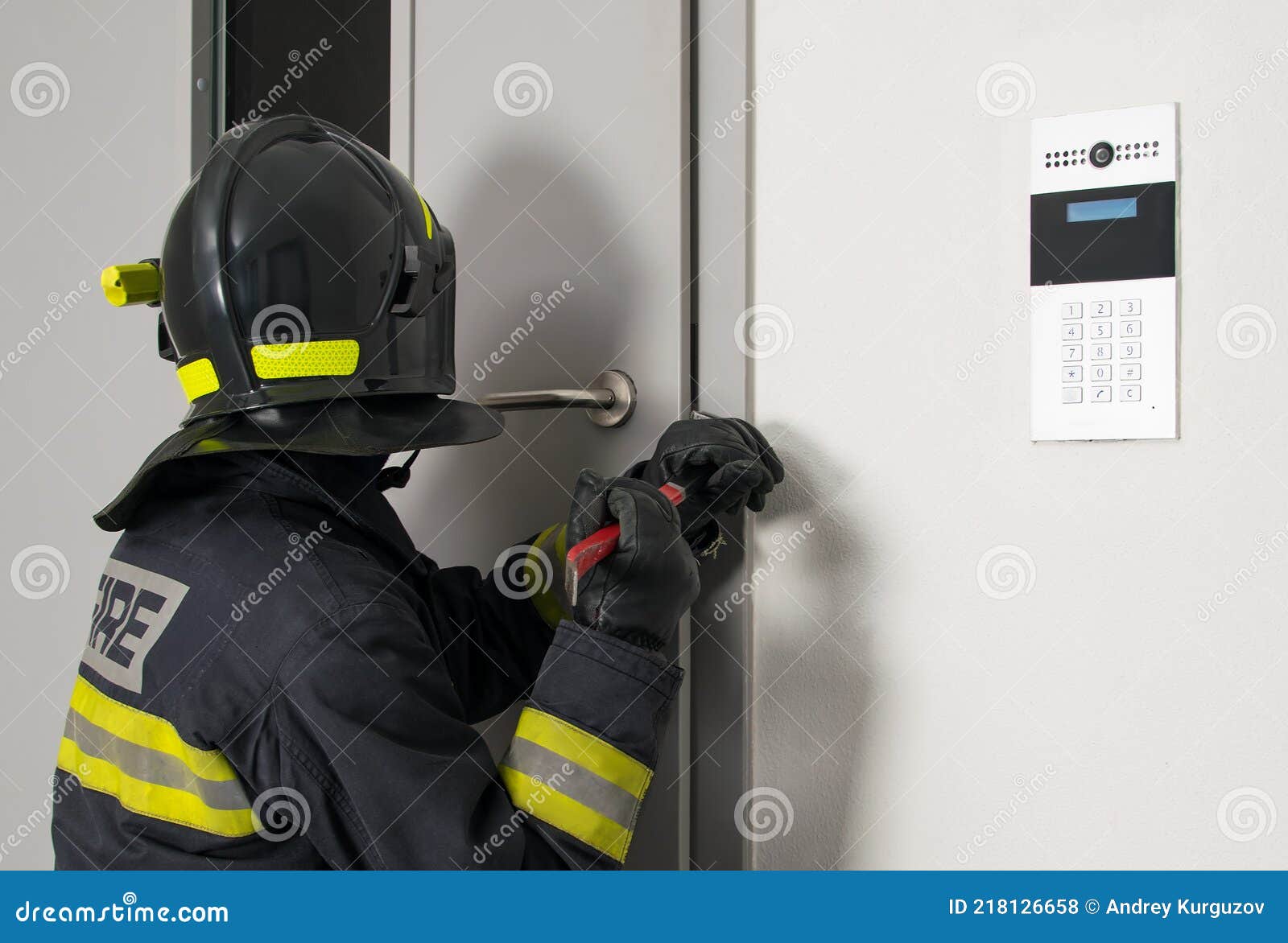 Firefighter in Protective Uniform and Helmet Opens the Closed Door ...