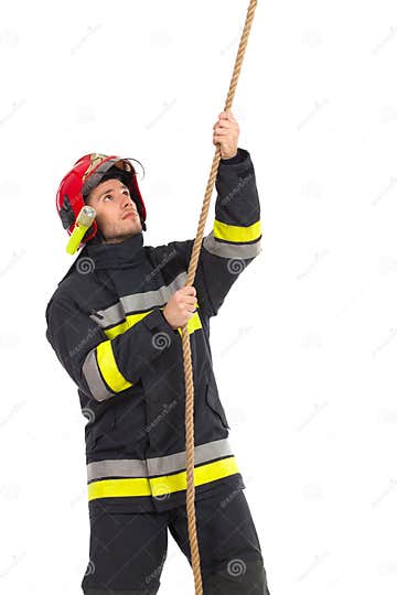 Firefighter pulling a rope stock photo. Image of coat - 38519672
