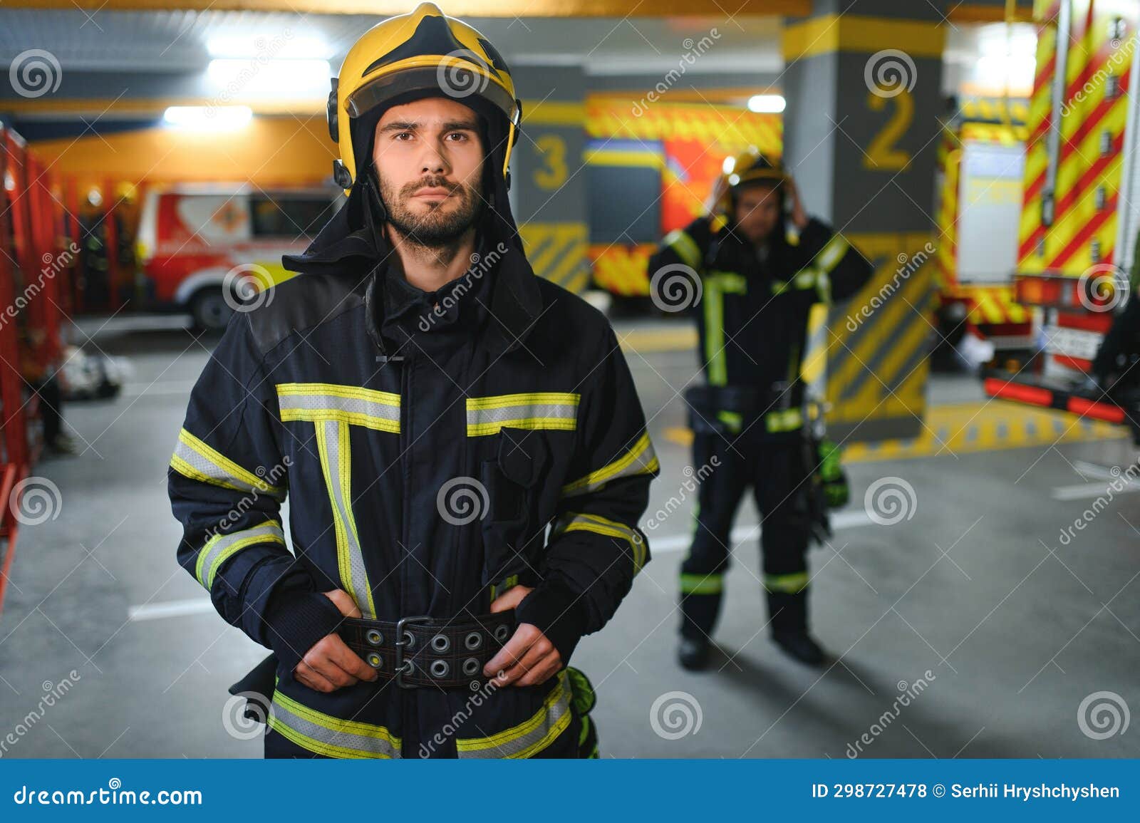 A Firefighter Puts on a Fire Uniform at the Fire Department Stock Photo ...