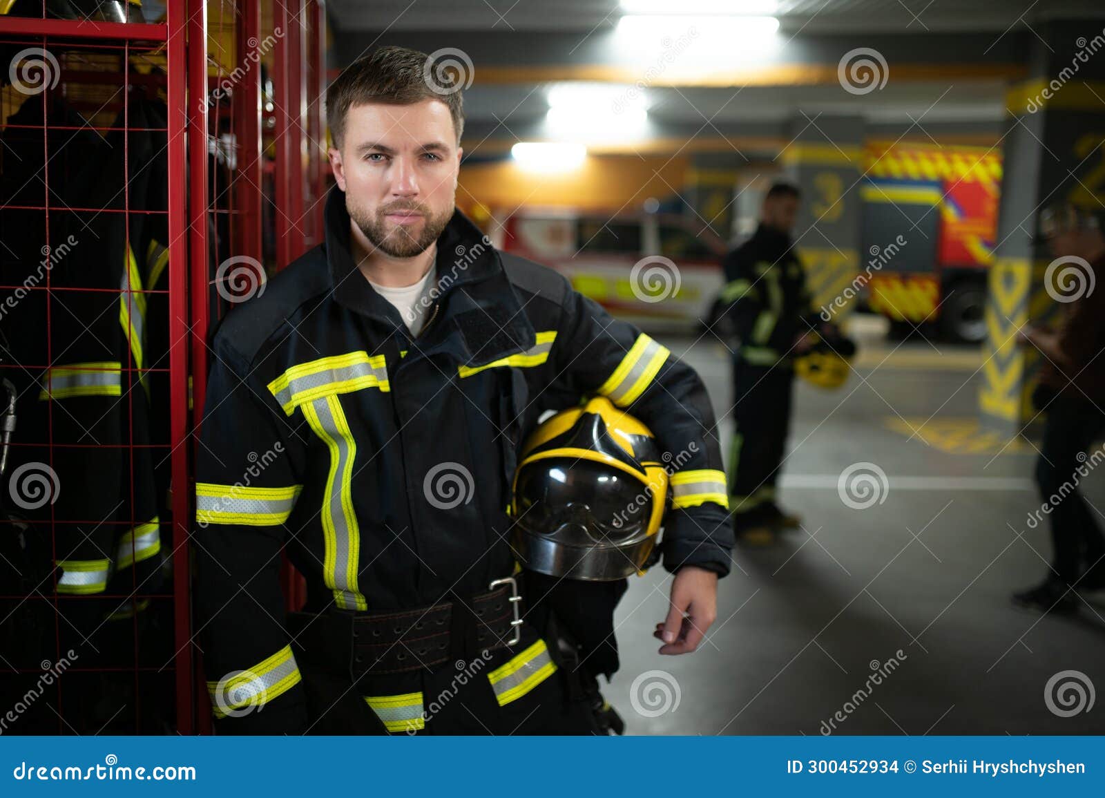 A Firefighter Puts on a Fire Uniform at the Fire Department Stock Photo ...