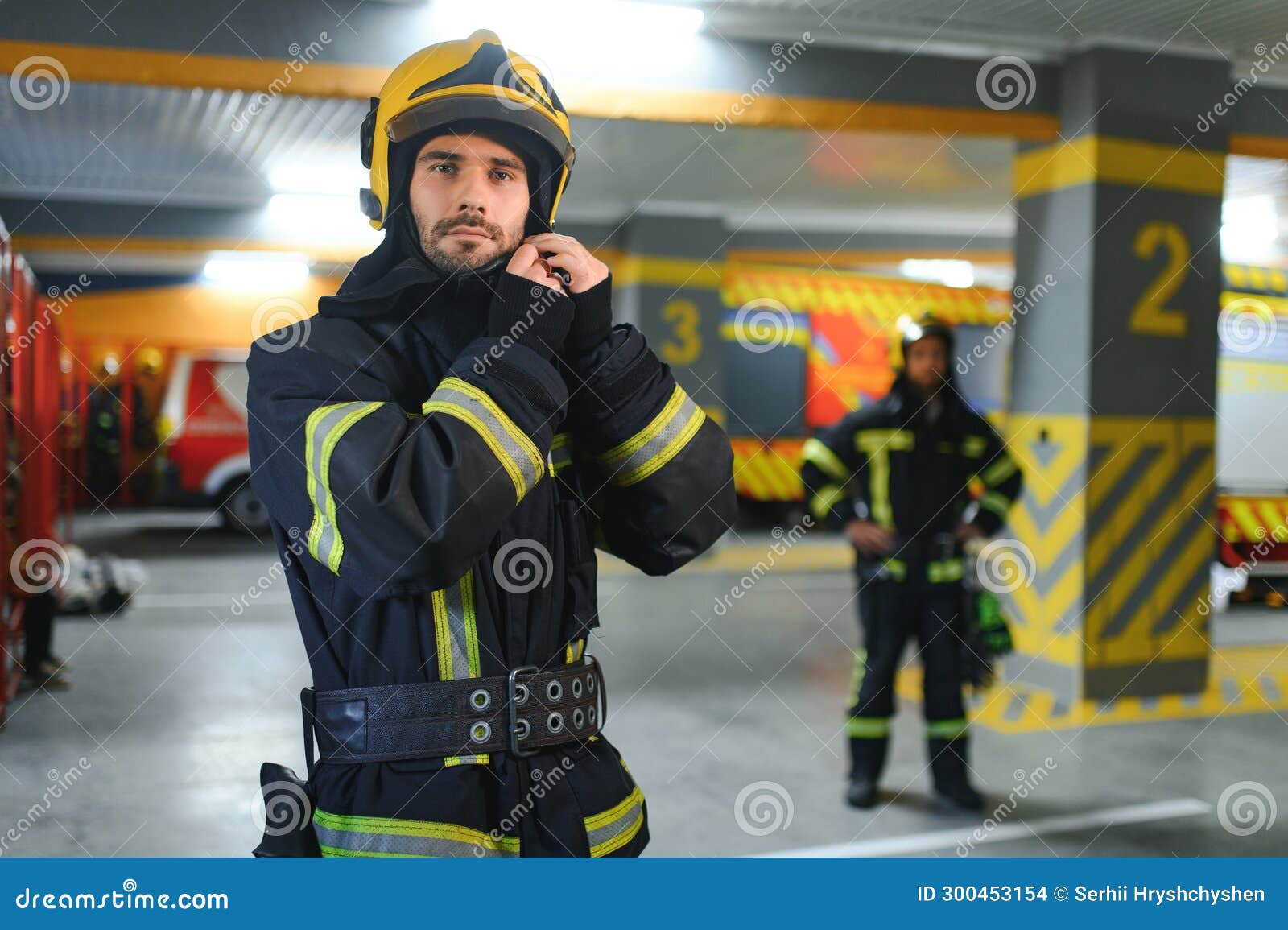 A Firefighter Puts on a Fire Uniform at the Fire Department Stock Photo ...