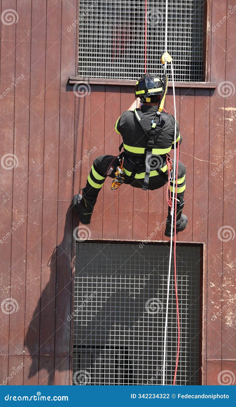 Firefighter is Rappelling Down the Building in Full Uniform a Stock ...
