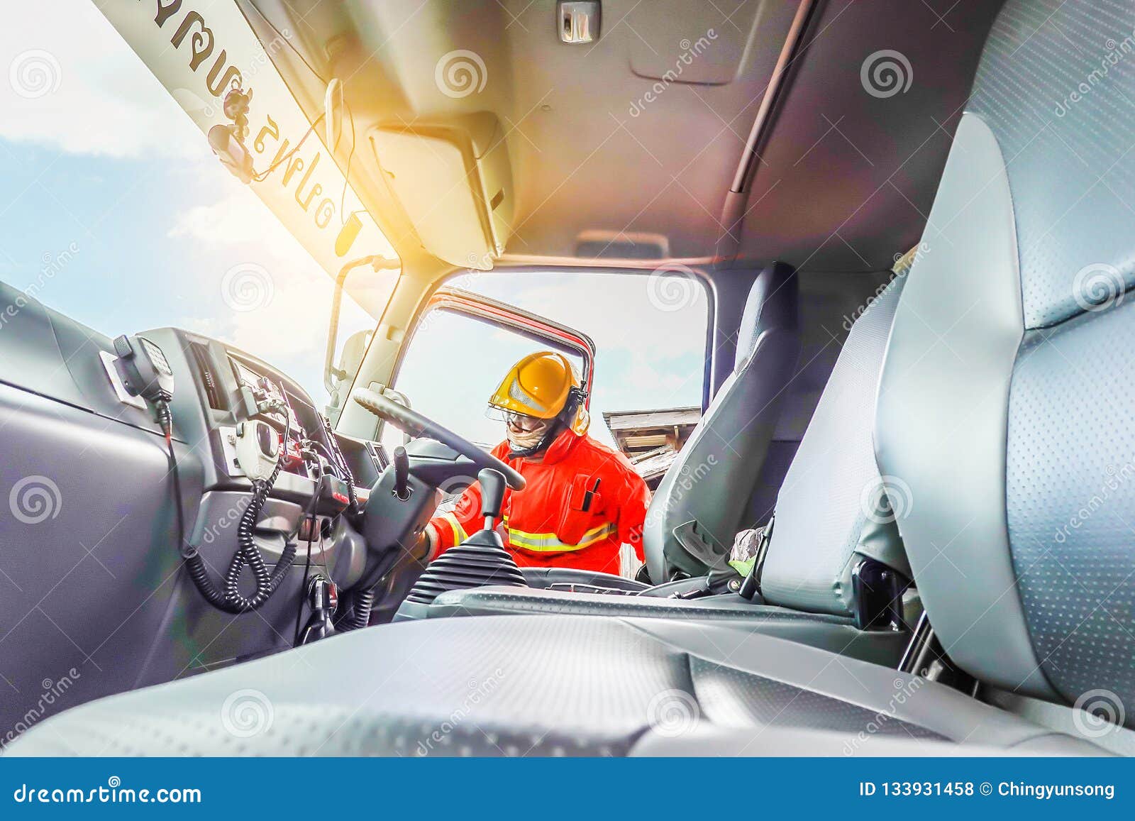 Firefighter the Rescuer Climbing into the Fire Truck Stock Photo ...