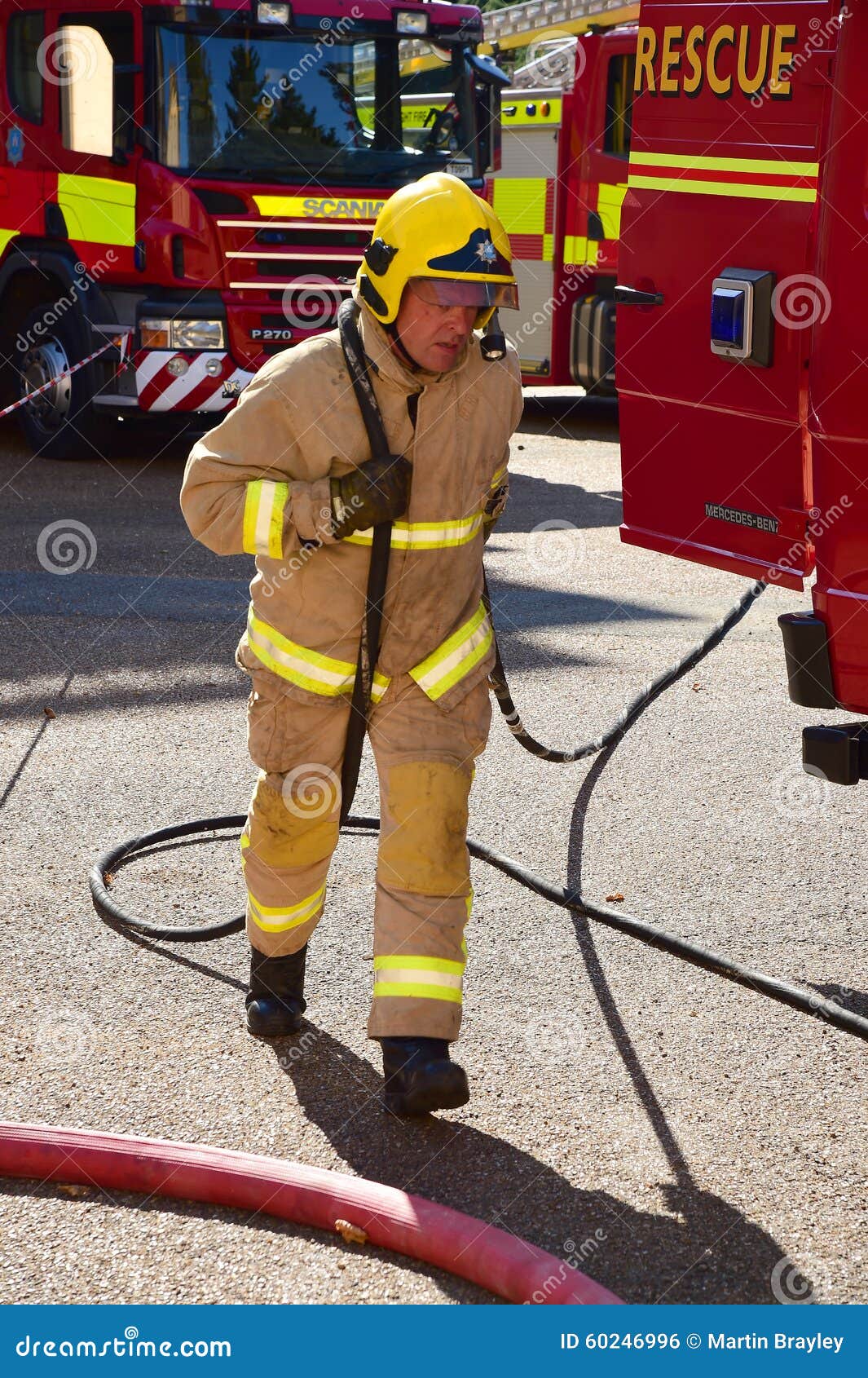Firefighter Runs Out a Hose at the Scene of a Fire. Editorial Photo ...
