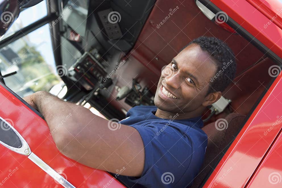 A Firefighter Sitting in the Cab of a Fire Engine Stock Image - Image ...