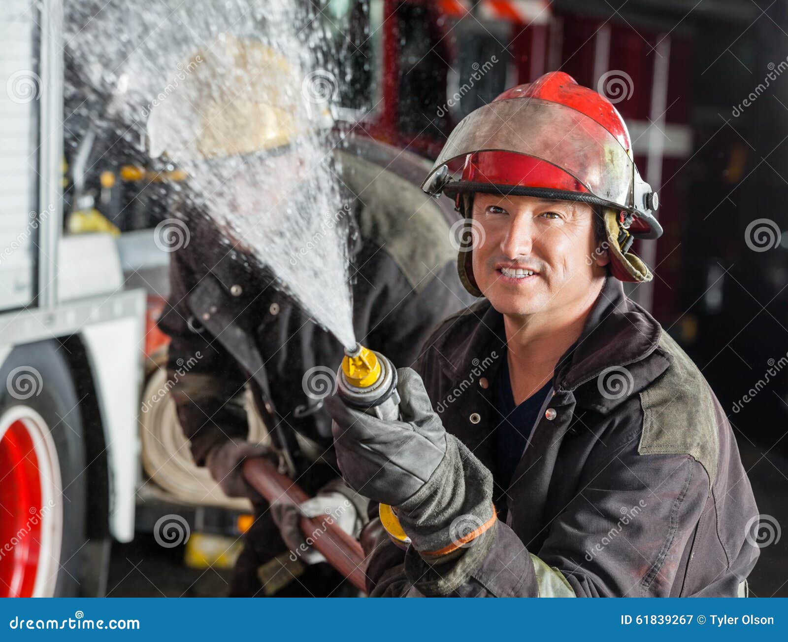 Firefighter Spraying Water while Practicing with Stock Image - Image of ...