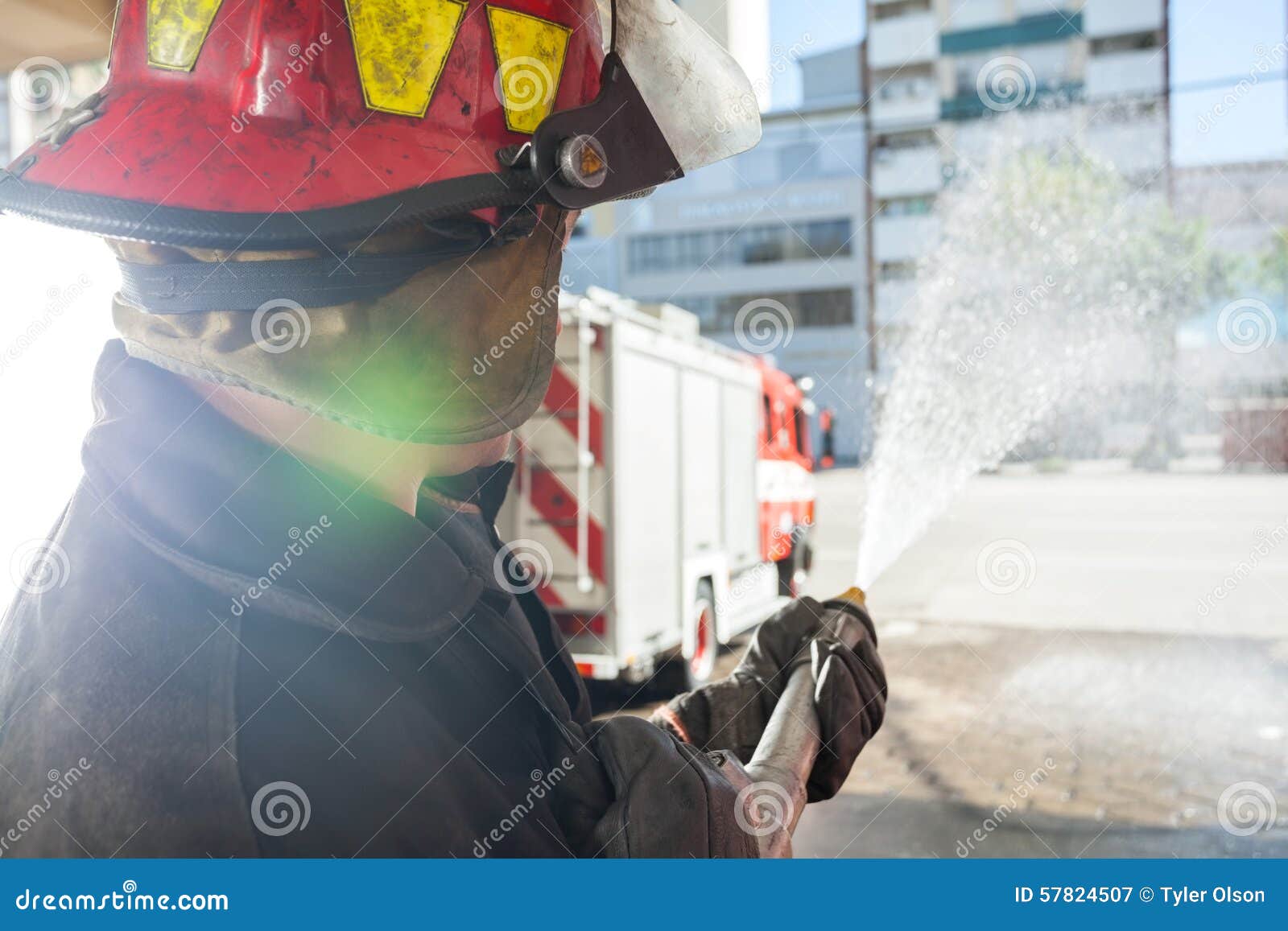 Firefighter Spraying Water while Practicing at Stock Image - Image of ...