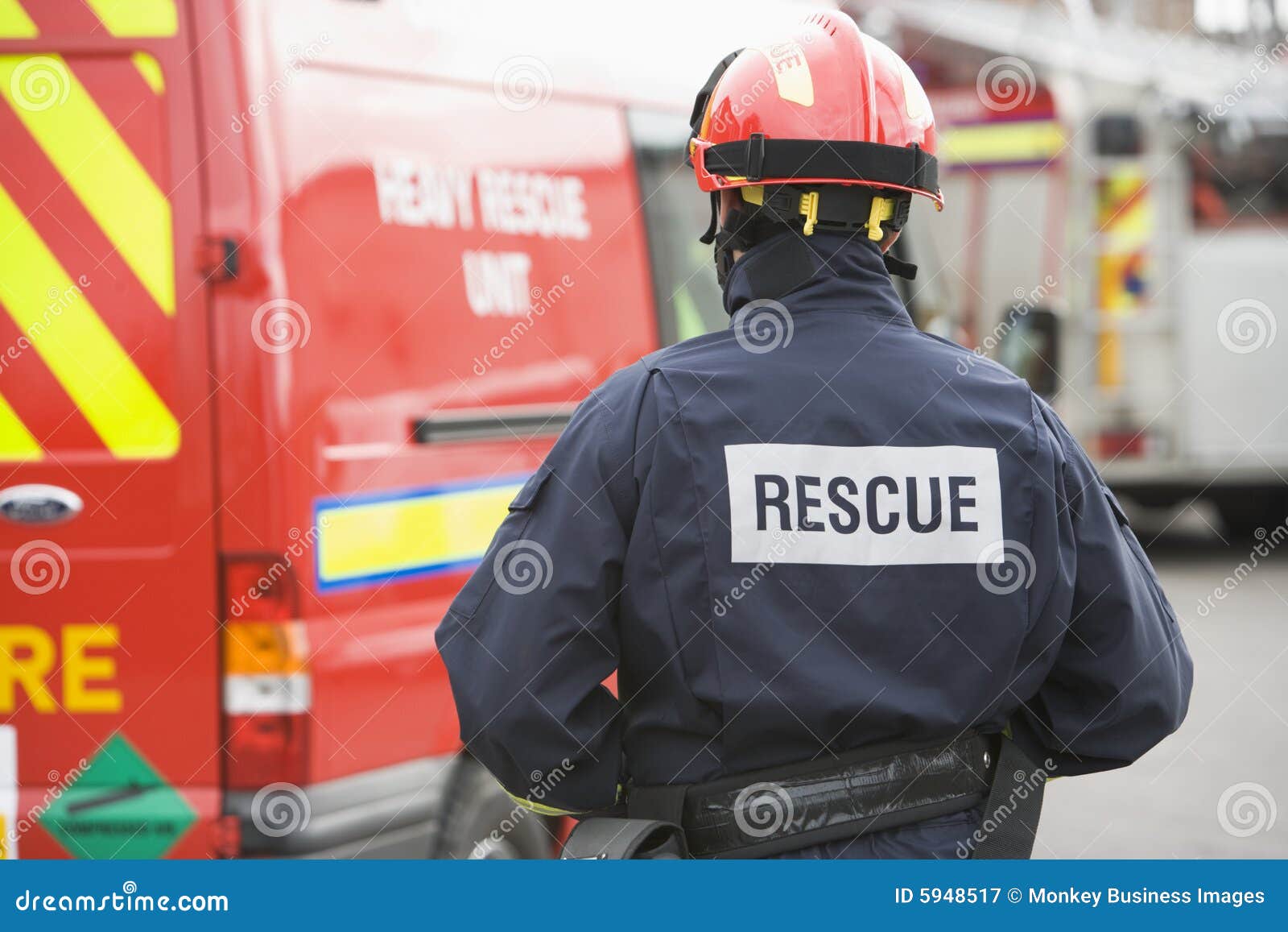 A Firefighter Standing by a Small Fire Engine Stock Image - Image of ...