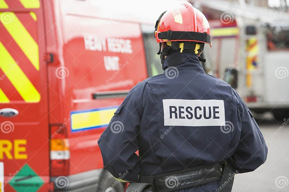 A Firefighter Standing by a Small Fire Engine Stock Image - Image of ...